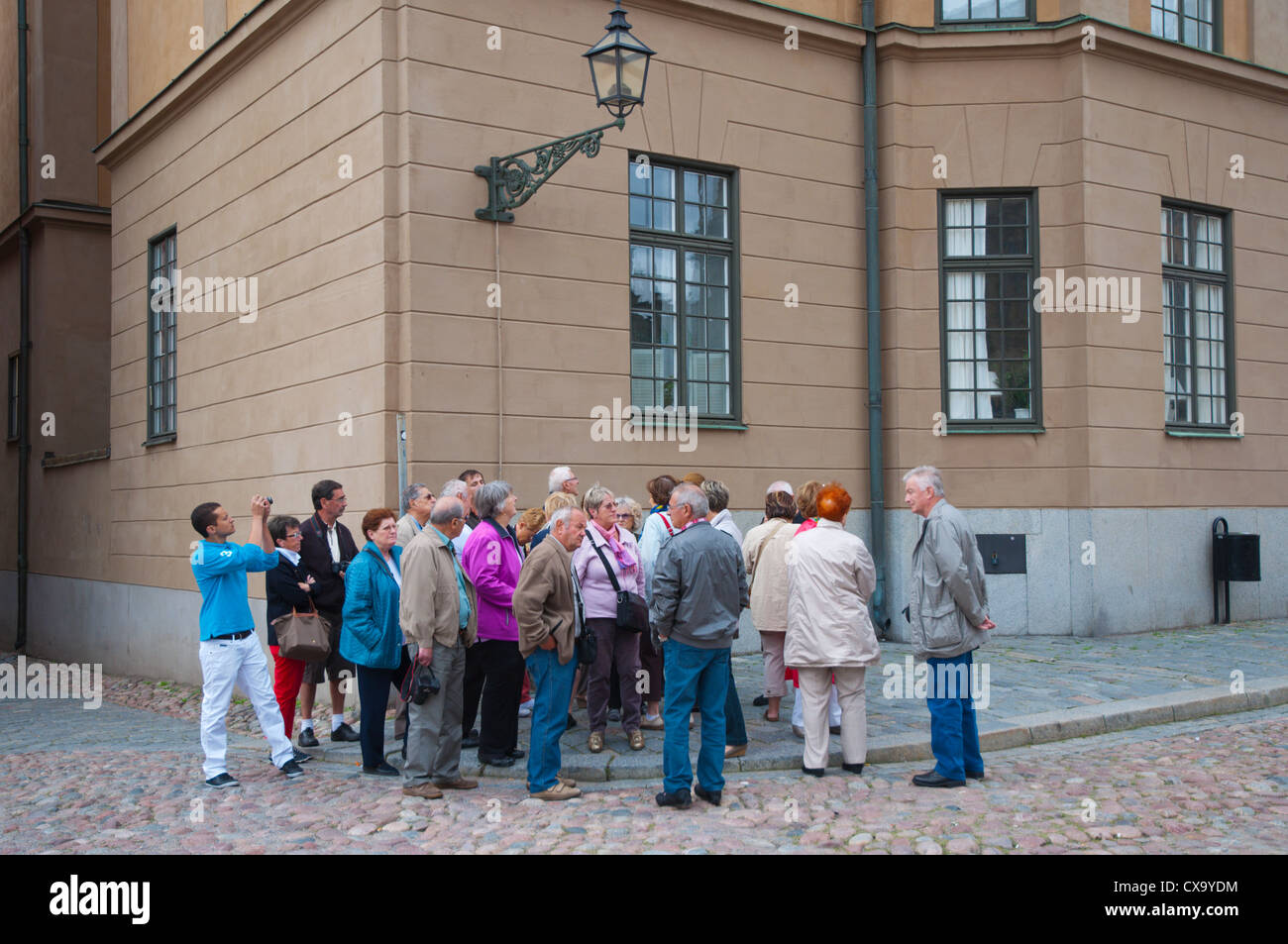 Tourist group at Slottsbacken square in front of Kungliga slottet the ...