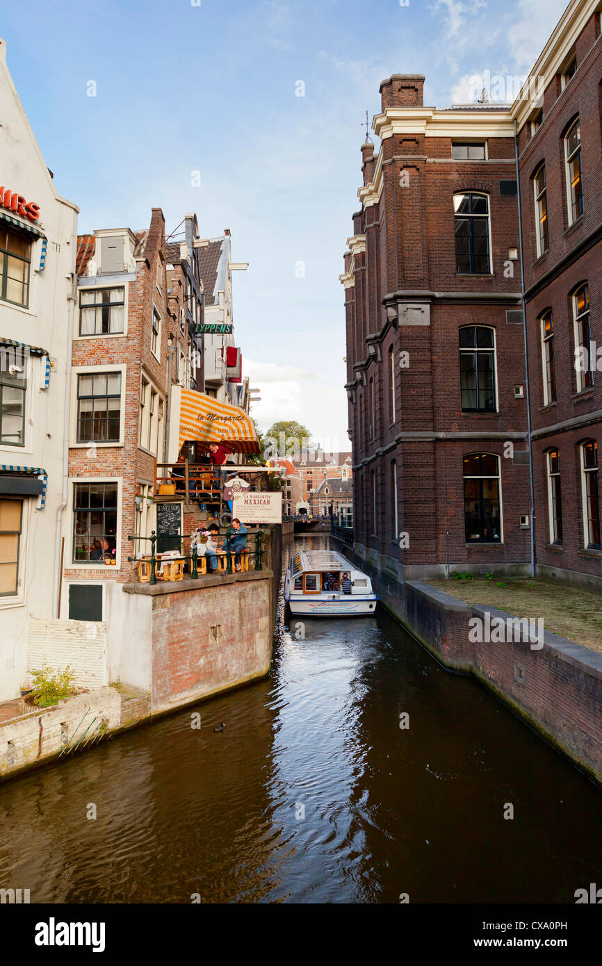 Amsterdam: Tourist sightseeing boat entering small canal - Amsterdam ...
