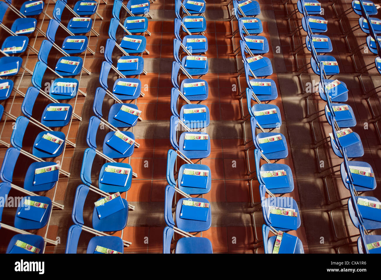 Programs on rows of seating for graduation ceremony in large hall ...