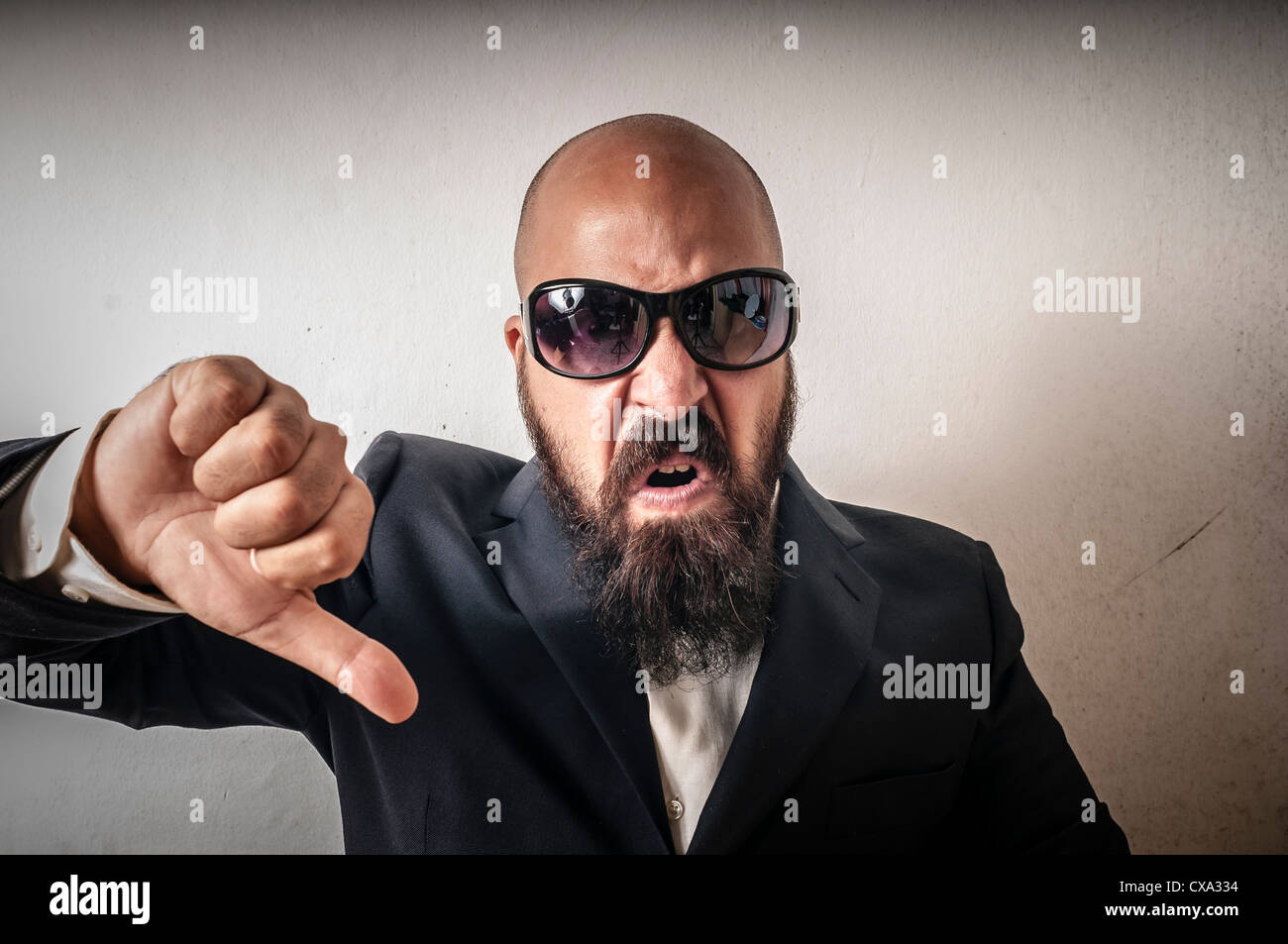 man bouncer with sunglasses and negative expression on white background ...