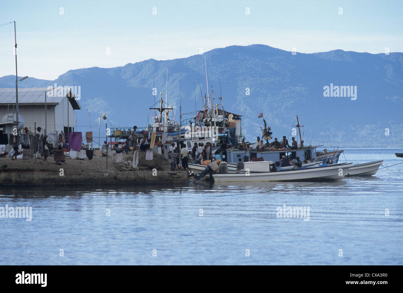 Papua New Guinea, Alotau, Sanderson Harbour and boats in the early ...