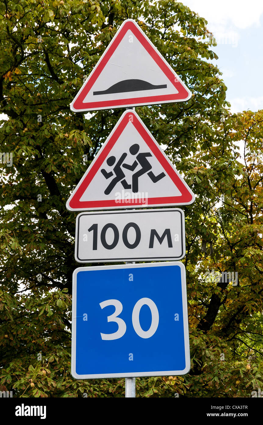 Road sign indicating children crossing and speed bump Stock Photo - Alamy