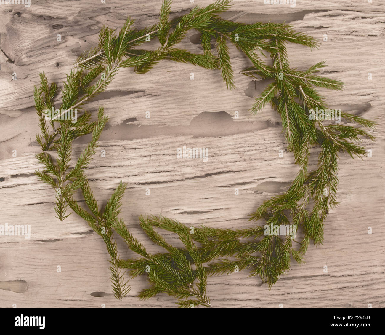 Wreath of fir branches against a wooden background Stock Photo - Alamy