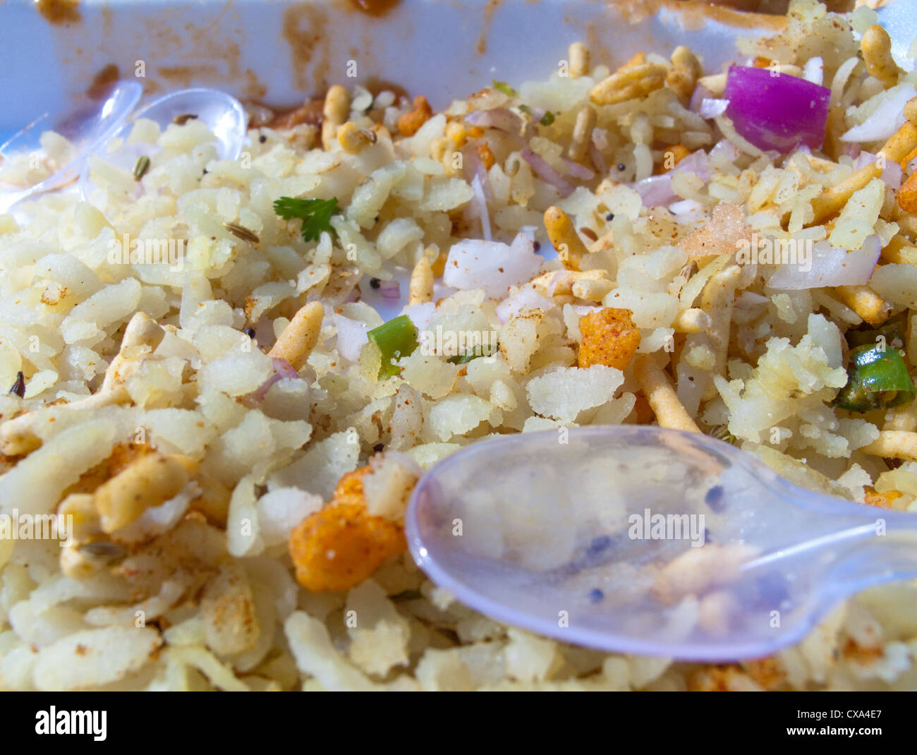 Cut pieces of Onion, Chillis, puffed rice and other salted items with a ...