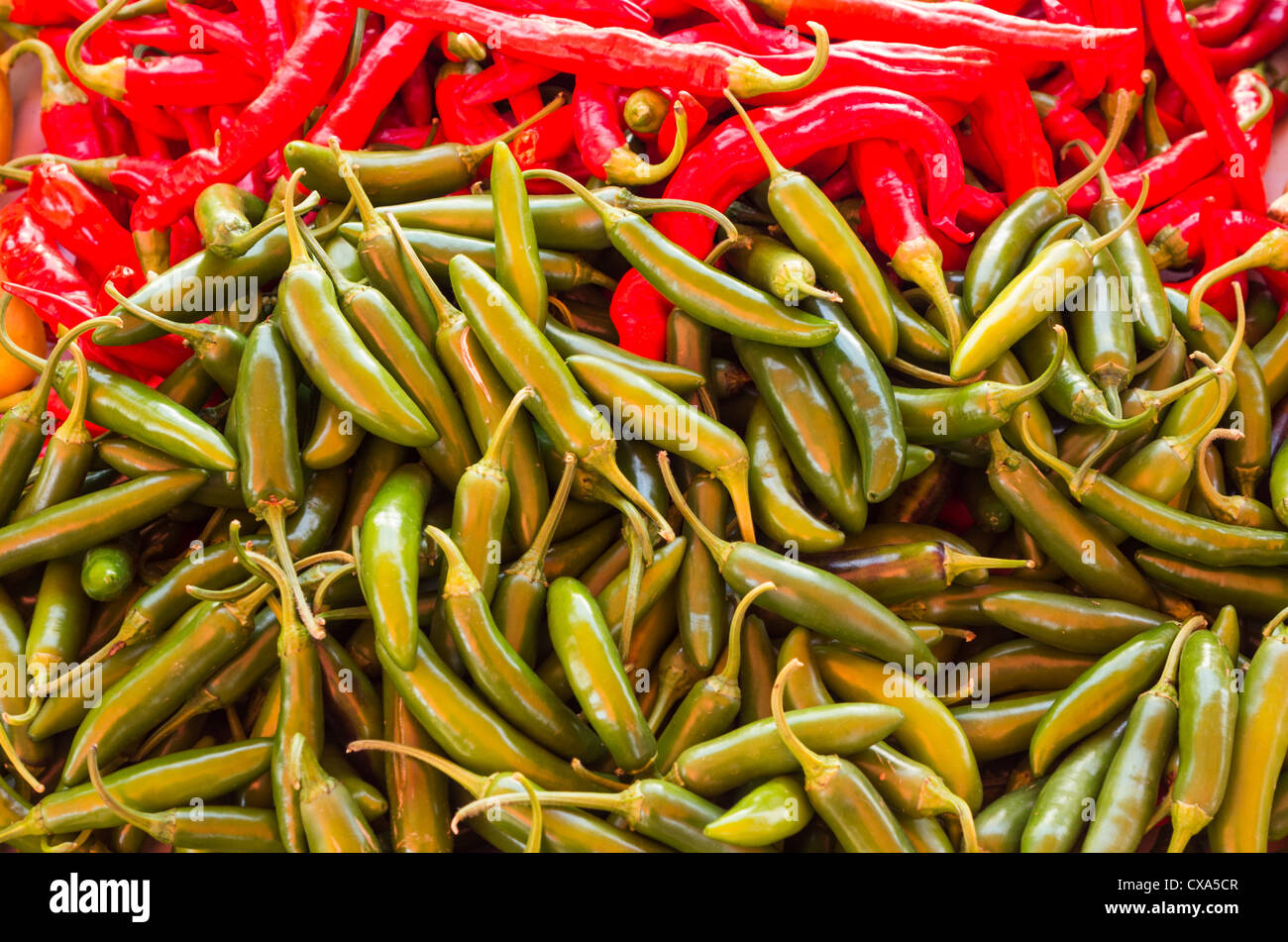 Fresh red and green hot peppers on display at the market Stock Photo ...