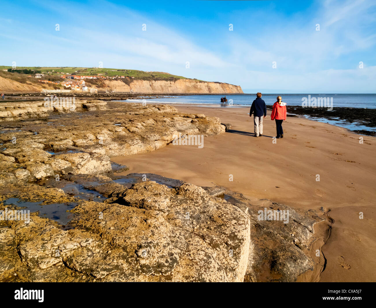 Couple and horse on beach at Boggle Hole near Robin Hood's Bay on the ...