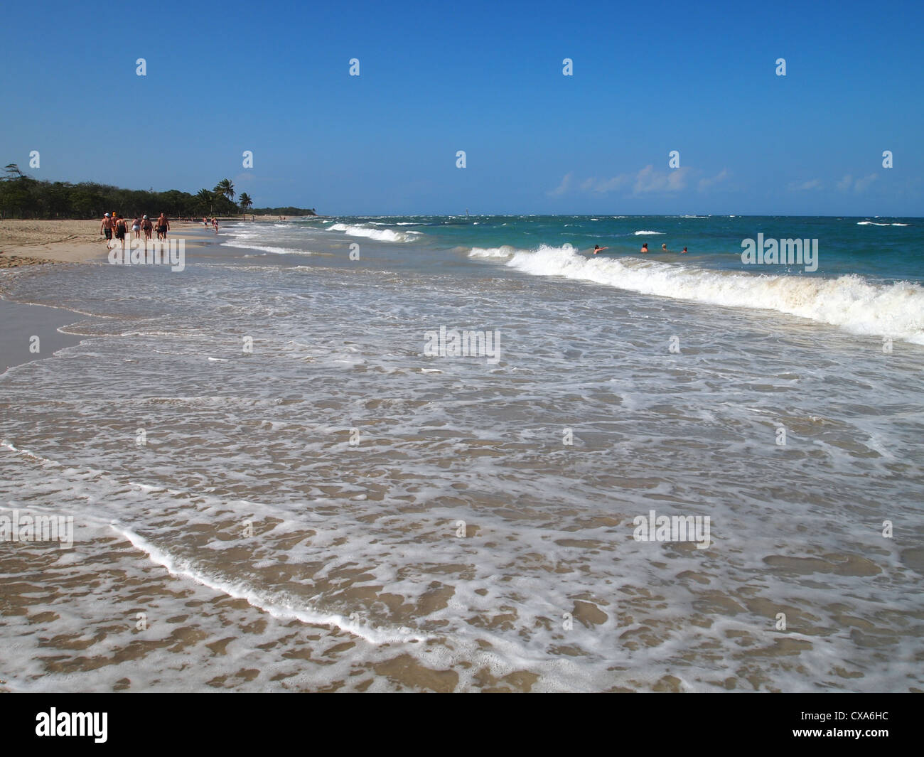 Walking on a wavy beach Stock Photo - Alamy