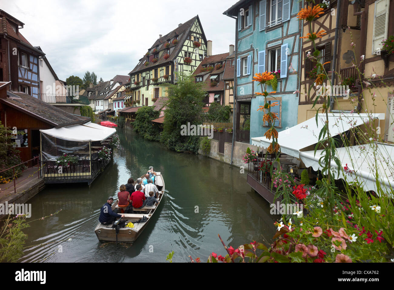 Tourist boat on canal in Petit Venice ( little Venice ) Colmar Alsace ...