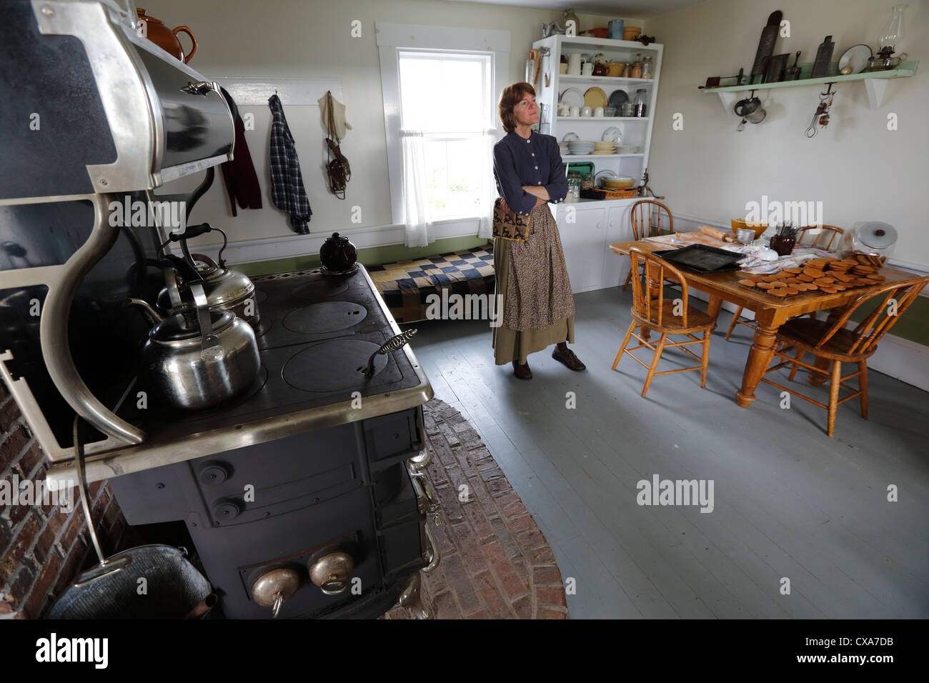 A woman in period costume inside the kitchen of a house, Historical ...