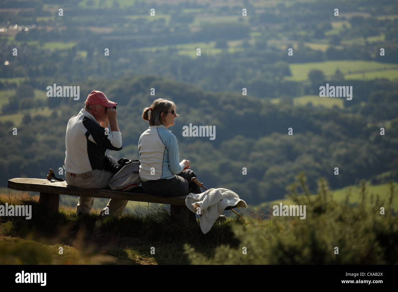 Two people sitting enjoying the view from the side of the Malvern Hills ...