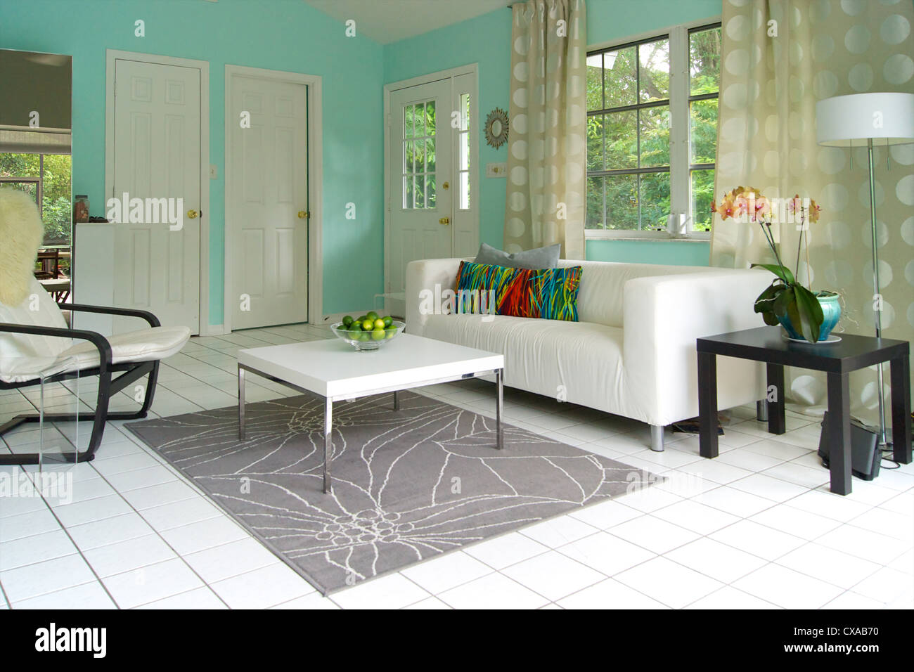 a well lit modern living room interior with white sofa Stock Photo - Alamy