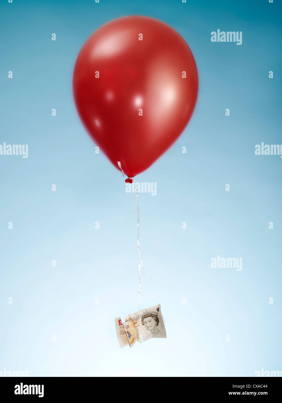 Ten pound note attached to floating red balloon Stock Photo - Alamy
