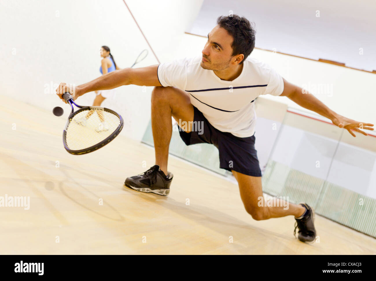 Hispanic couple playing squash Stock Photo - Alamy