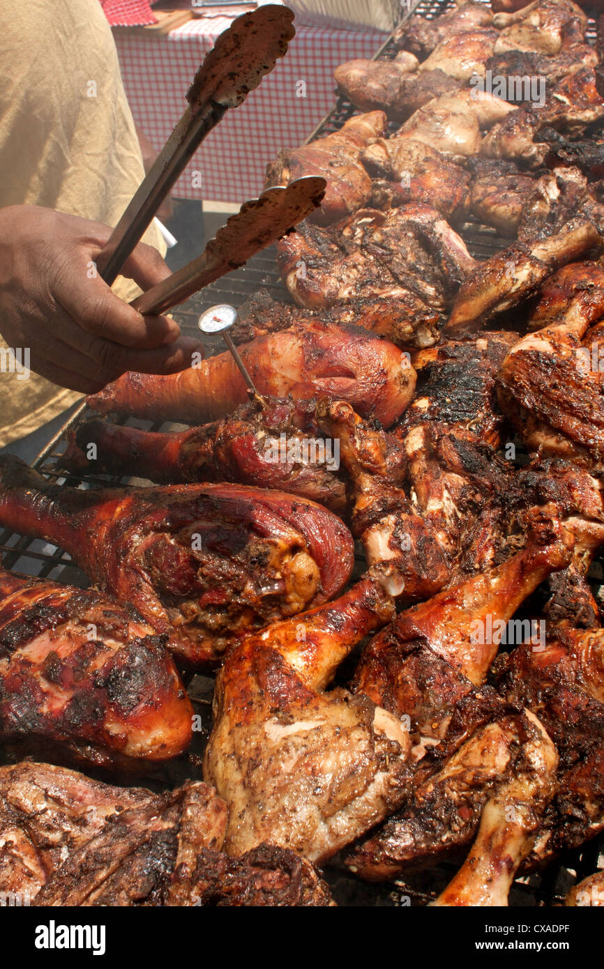 Large amounts of chicken barbeque on a grill at an outdoor arts ...