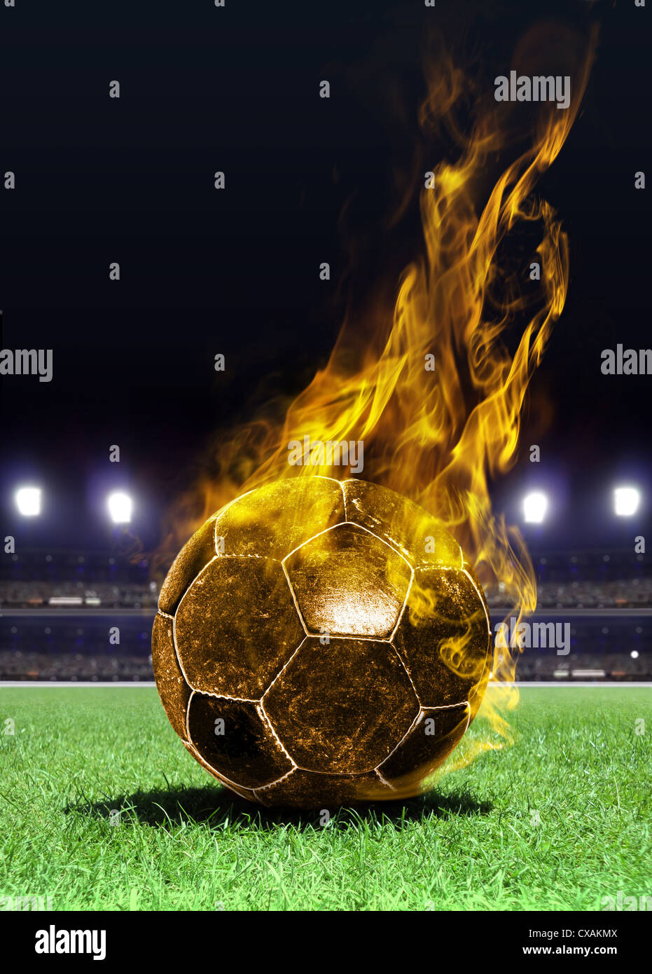 fiery soccer ball on playing field of stadium Stock Photo - Alamy