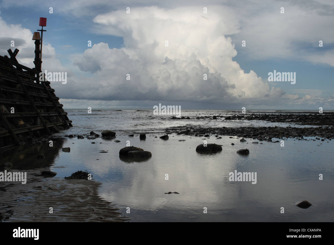 Beach and harbour wall with storm clouds over sea Aberaeron Stock Photo ...
