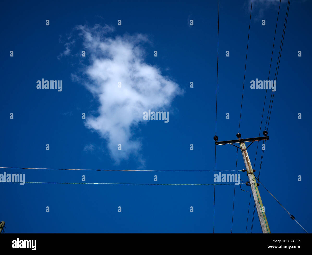 Single cloud with electricity pole in the UK Stock Photo - Alamy