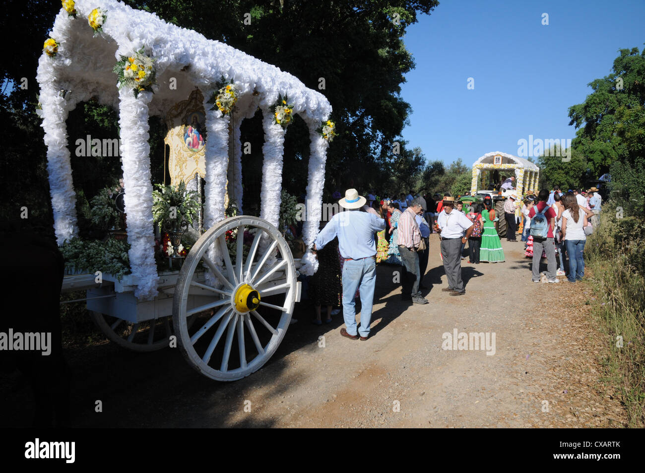 Crowd follows carriage pulled by two oxen on Romeria Stock Photo - Alamy