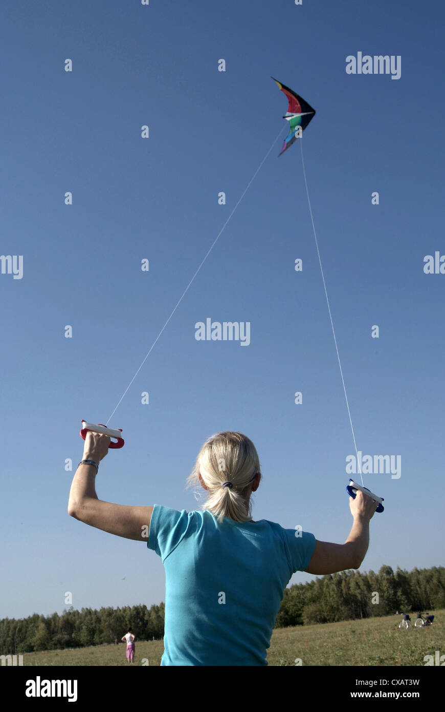 Berlin, a woman can fly a kite Stock Photo - Alamy
