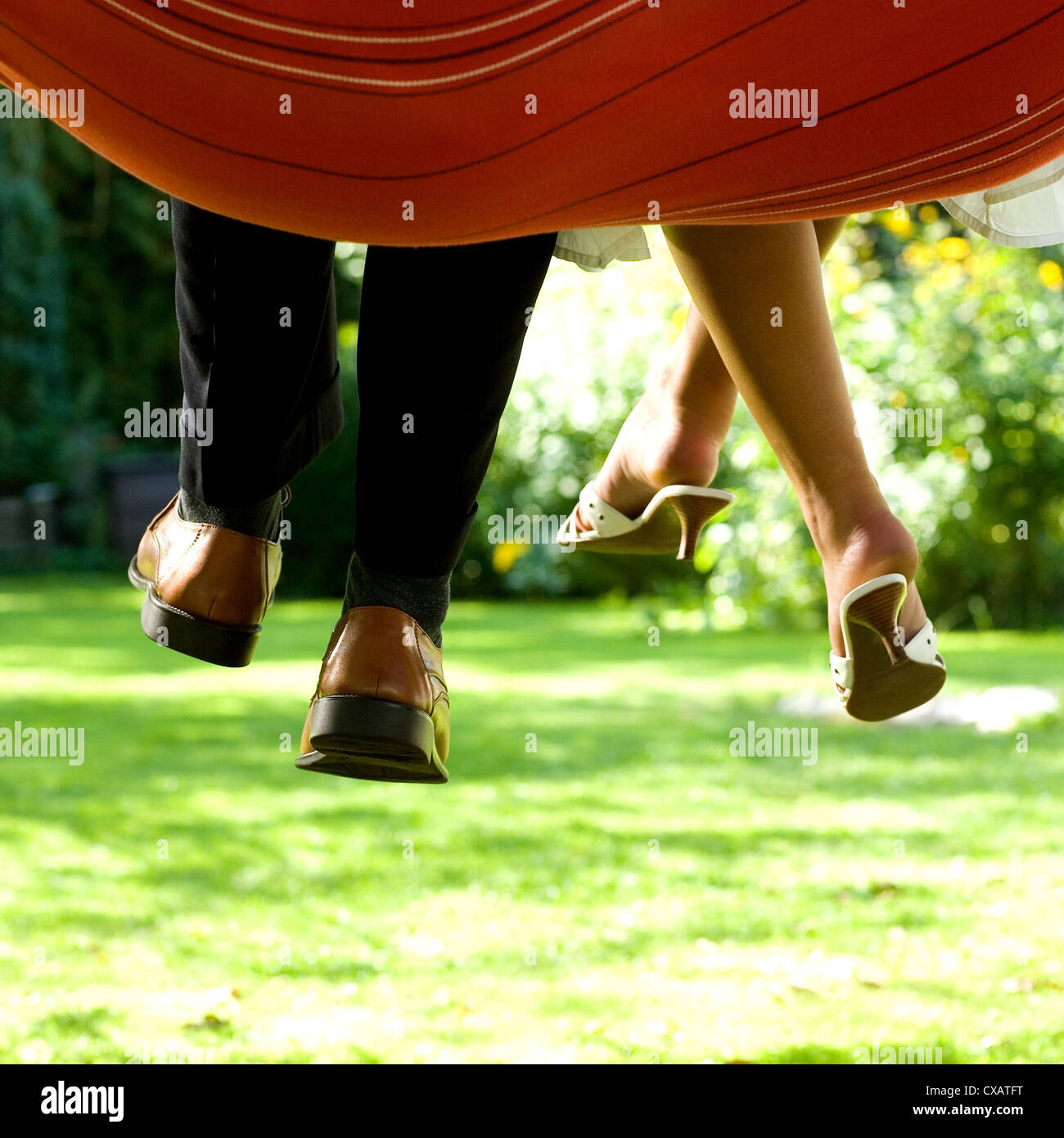 Berlin, legs dangling from the hammock Stock Photo - Alamy