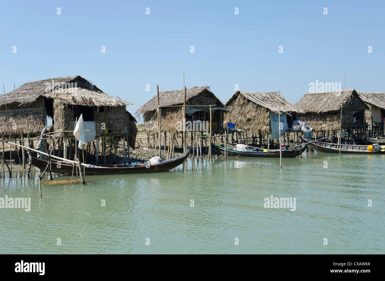Bamboo huts and boats along a waterway, Irrawaddy delta, Myanmar (Burma ...