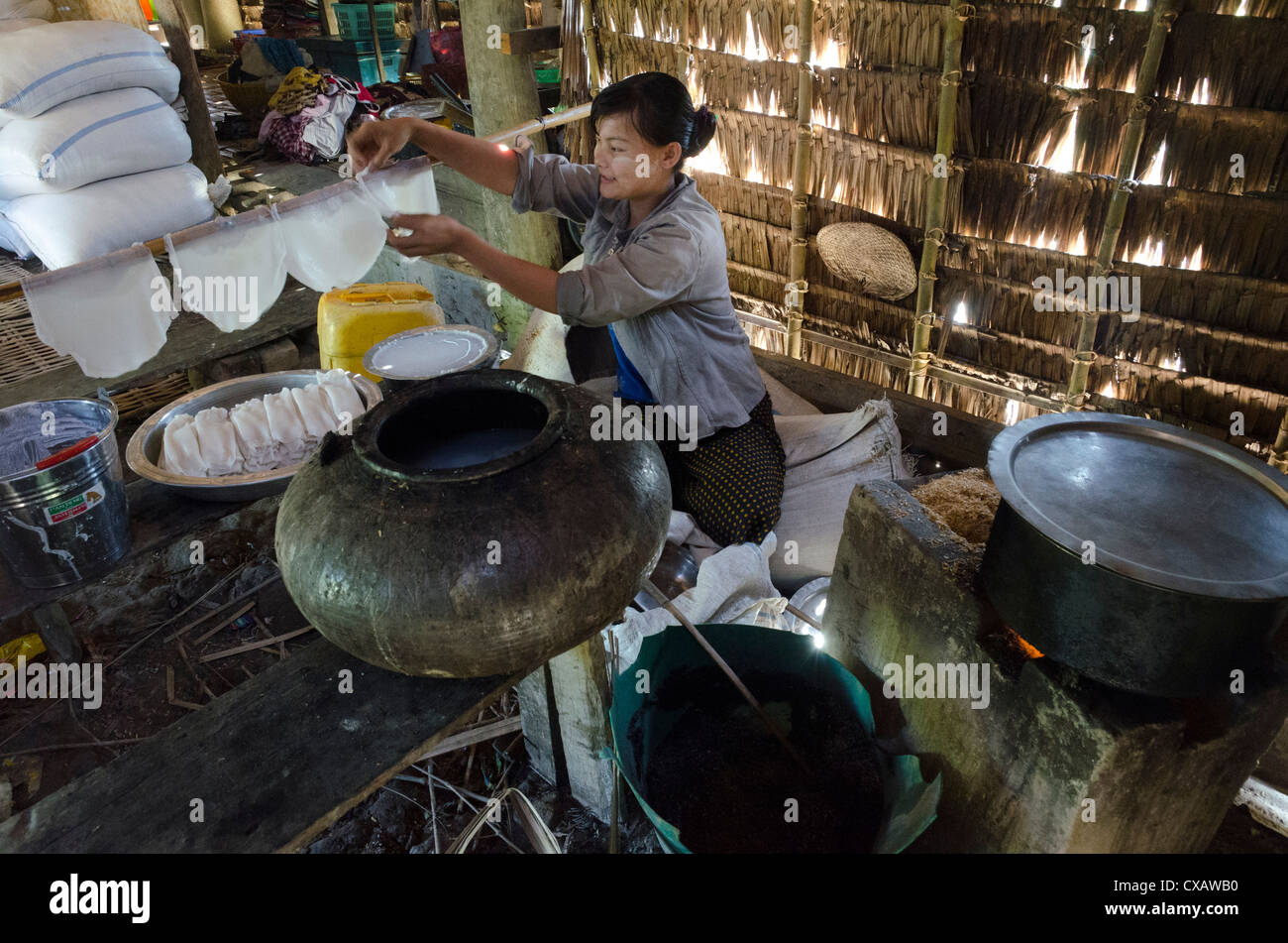 Young woman peparing rice noodles at home, Yae Saing Kone village ...