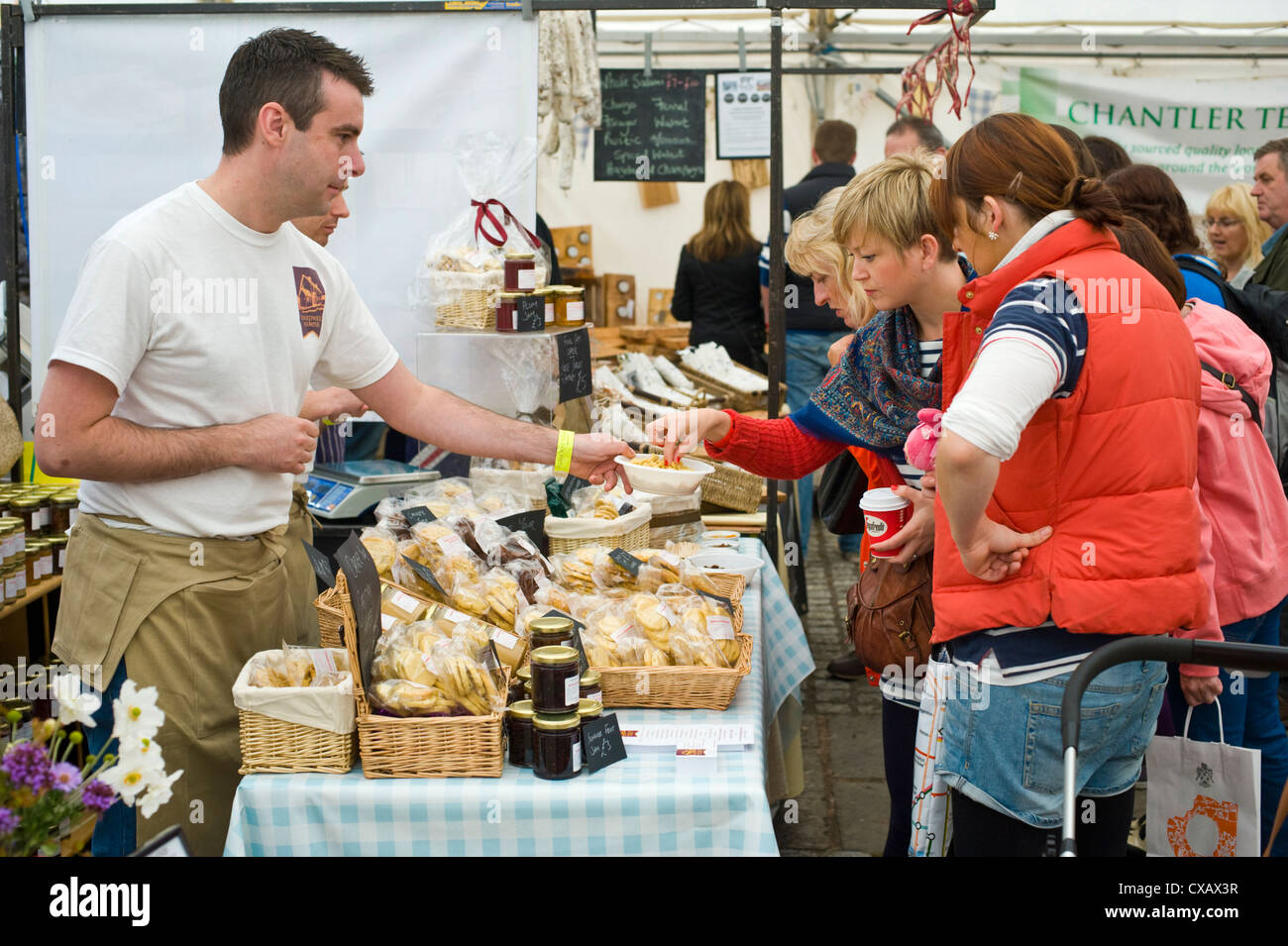 Women sampling savory biscuits on stall during Abergavenny Food ...