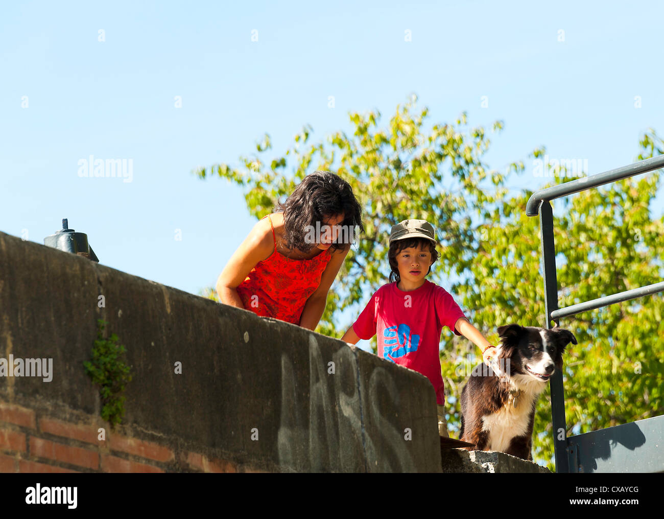 Mother and Son with Collie Dog Peering Over a Lock Wall into Tourist ...