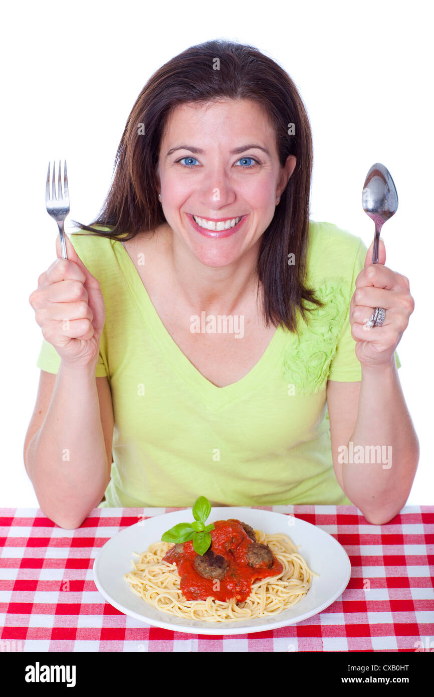 Pretty woman holding a fork with spaghetti portrait Stock Photo - Alamy