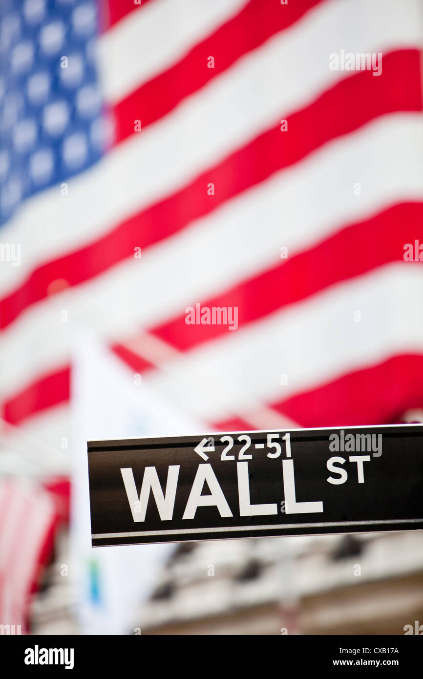 Wall street sign in New York with New York Stock Exchange background ...