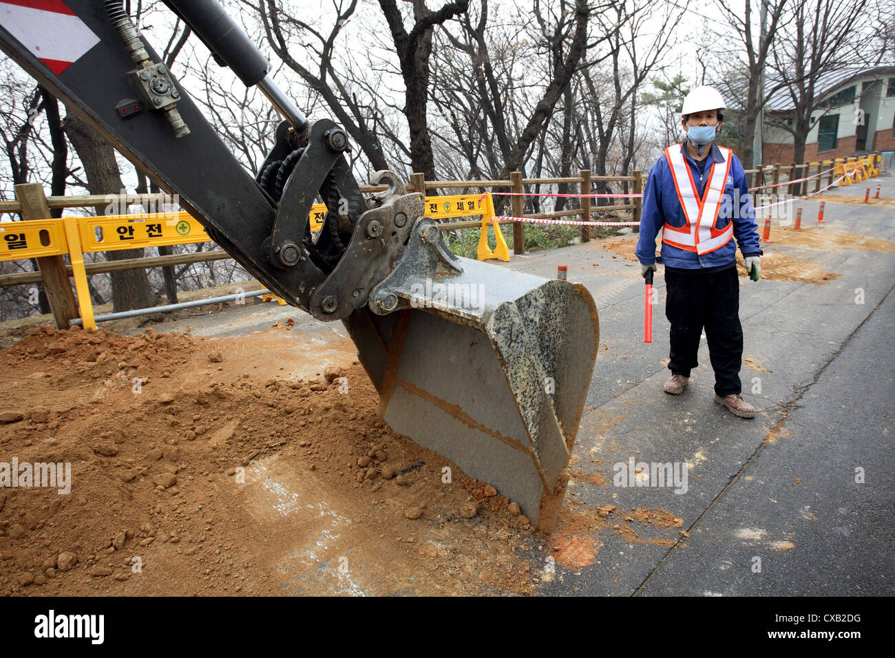 Seoul, road construction, construction workers wearing surgical masks ...