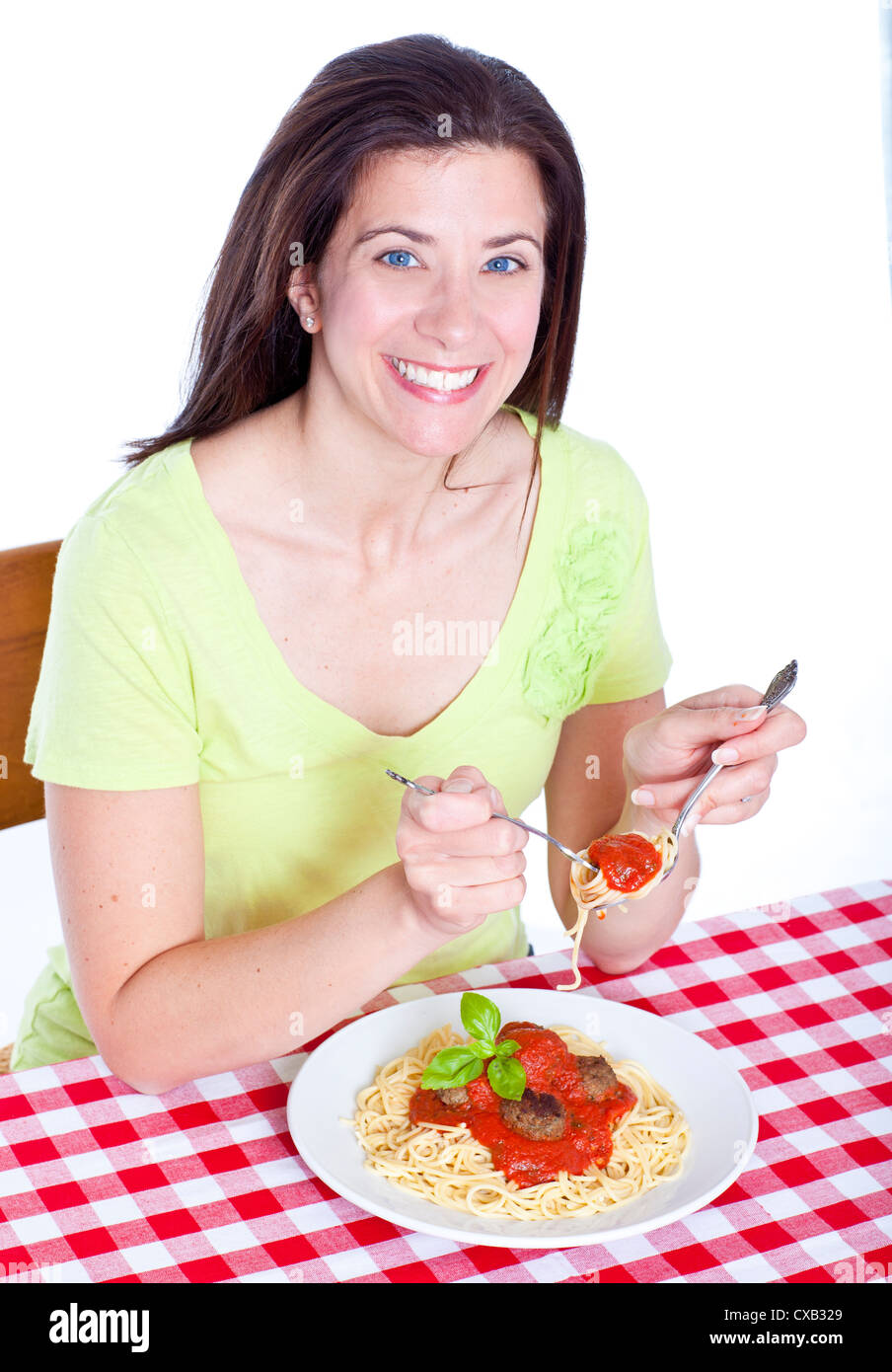 Pretty woman holding a fork with spaghetti portrait Stock Photo - Alamy