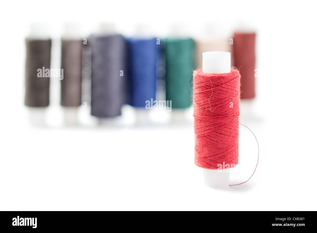 different colors thread spools isolated on white background Stock Photo ...