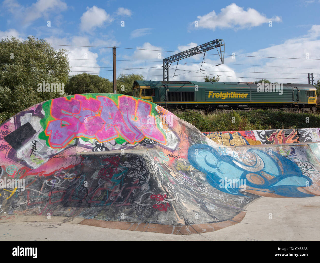 Freight train past graffiti art by Lea Valley canal, legacy of London ...