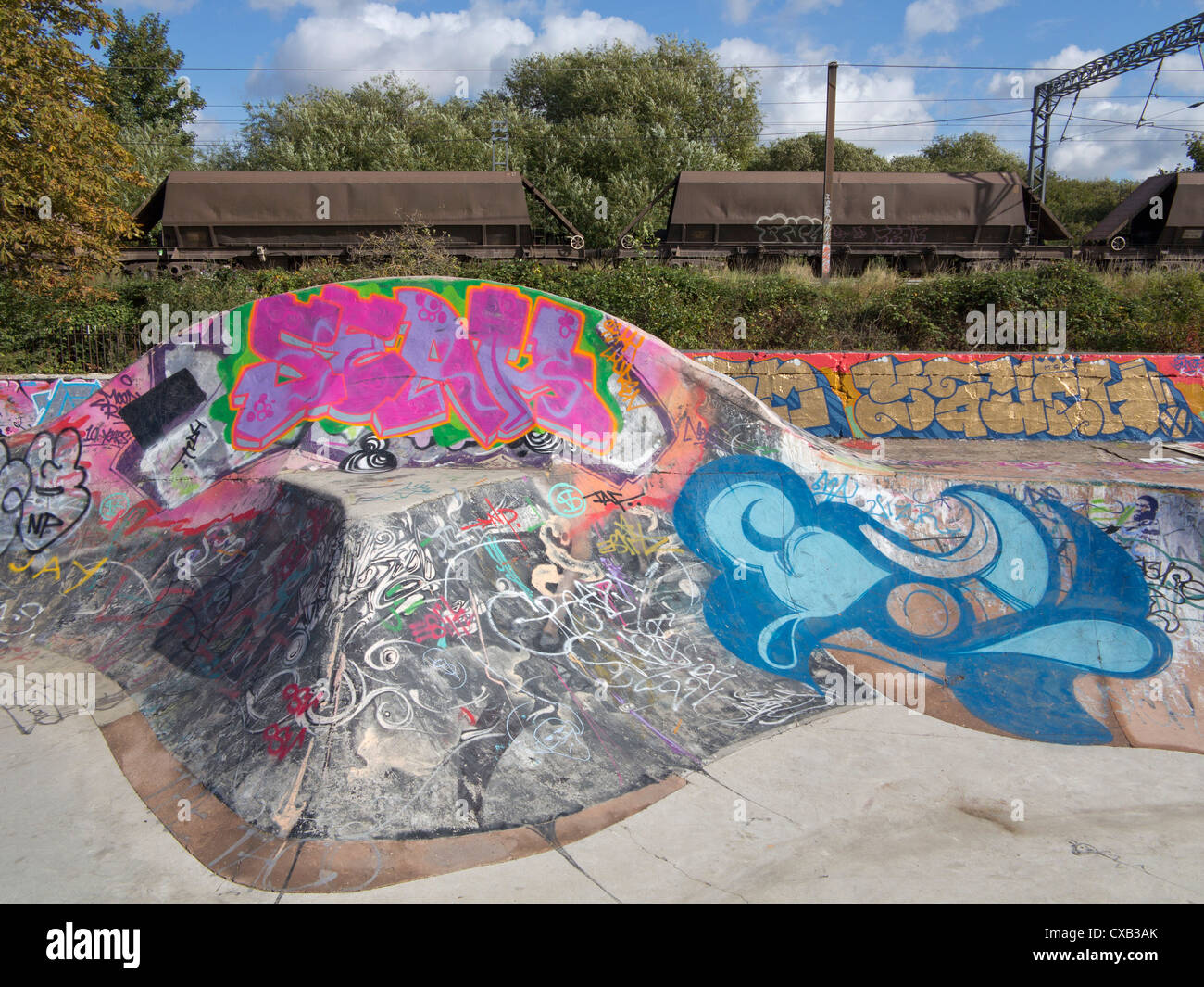 Freight train past graffiti art by Lea Valley canal, legacy of London ...