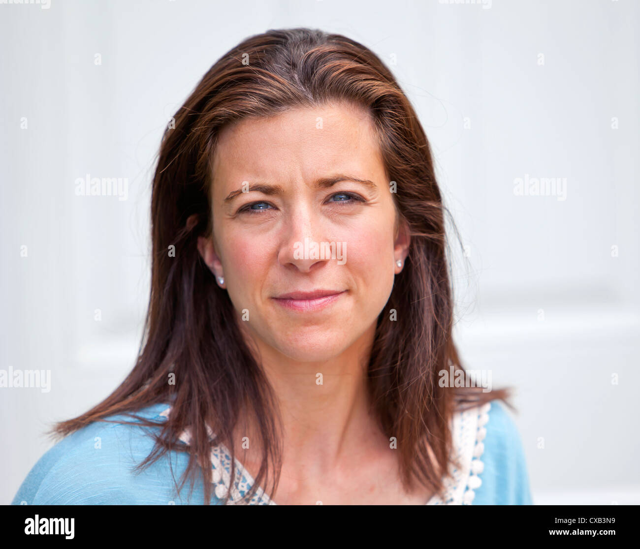 Pretty adult woman looking forward with sad expression Stock Photo - Alamy