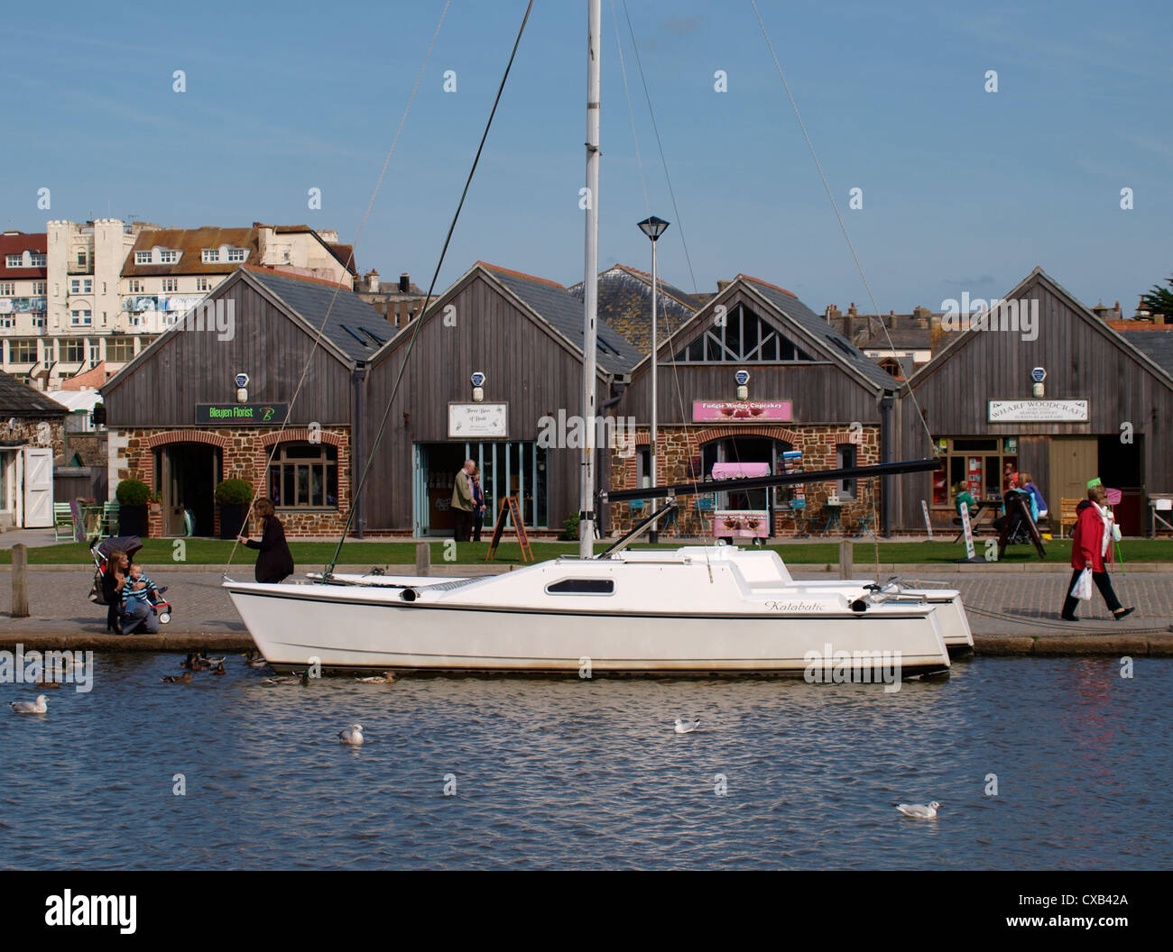 Yacht on the Bude canal in front of shops, Bude, Cornwall, UK Stock ...