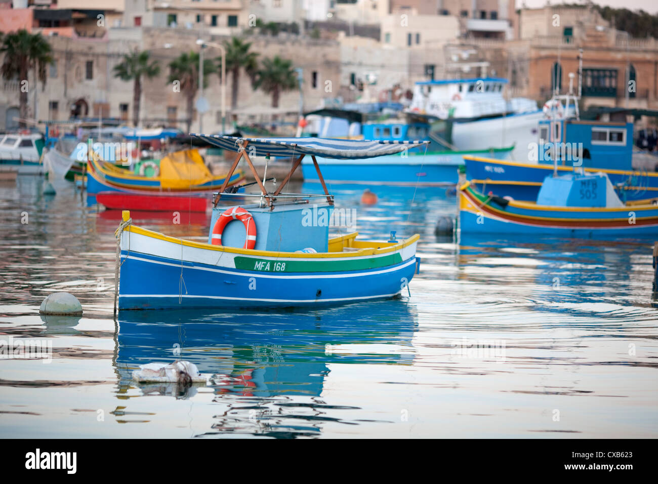 Colourful traditional luzzu fishing boats Marsaxlokk harbour Malta ...