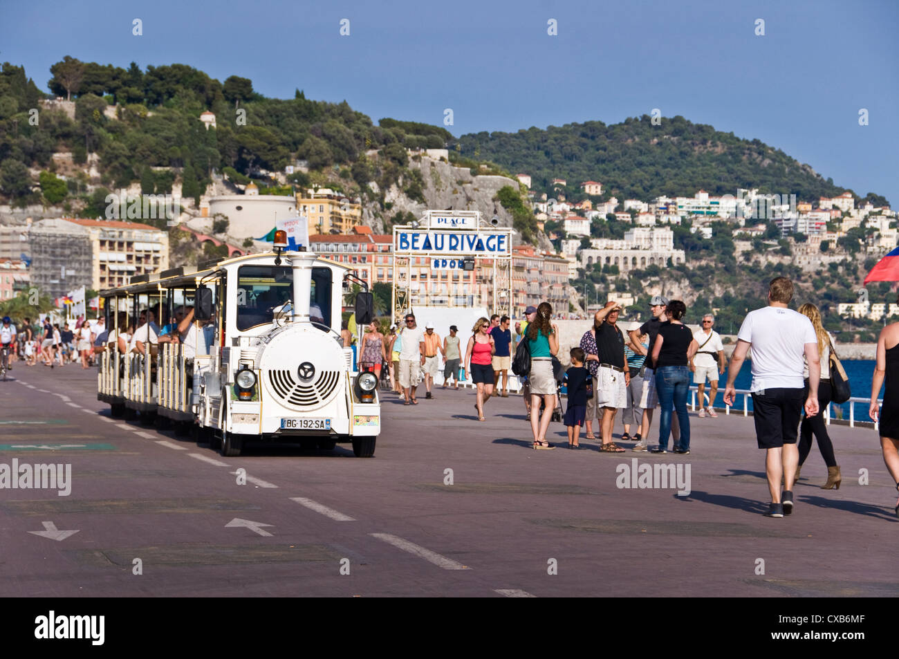 Touristic train and tourists during summer on the Promenade des Anglais ...