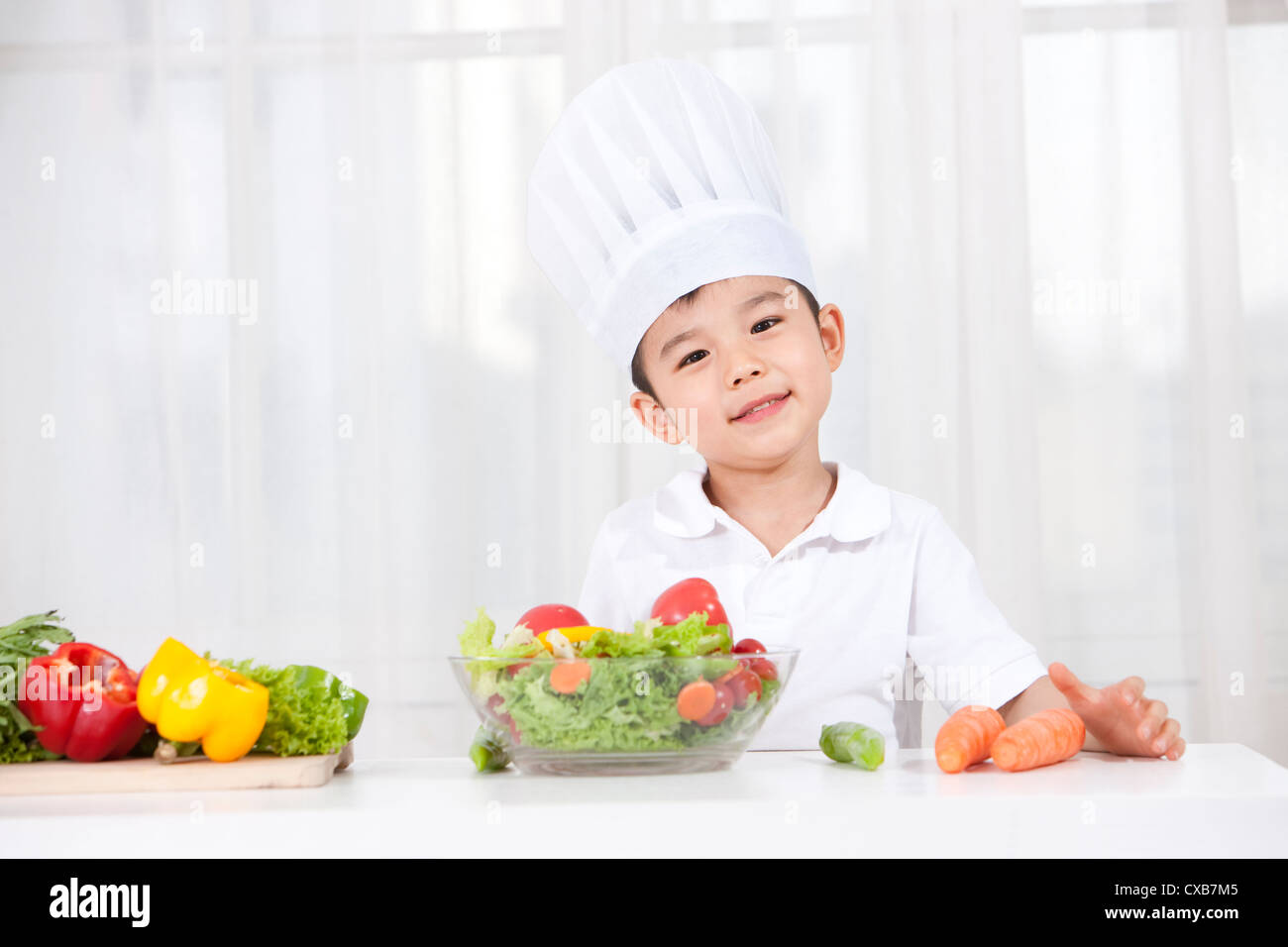 Young boy playing cooking Stock Photo - Alamy