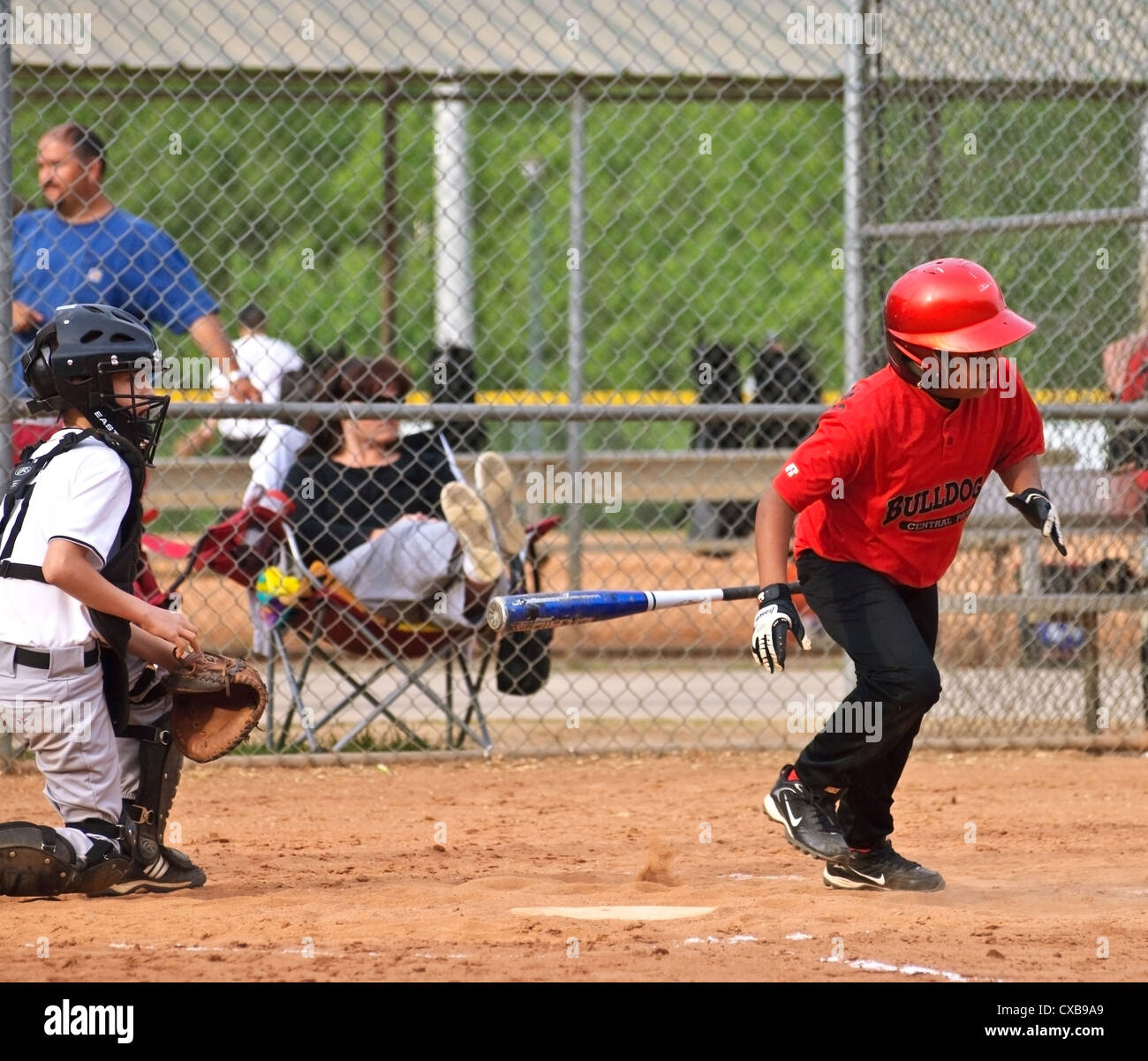 Young baseball player dropping the bat to run after making a hit Stock ...