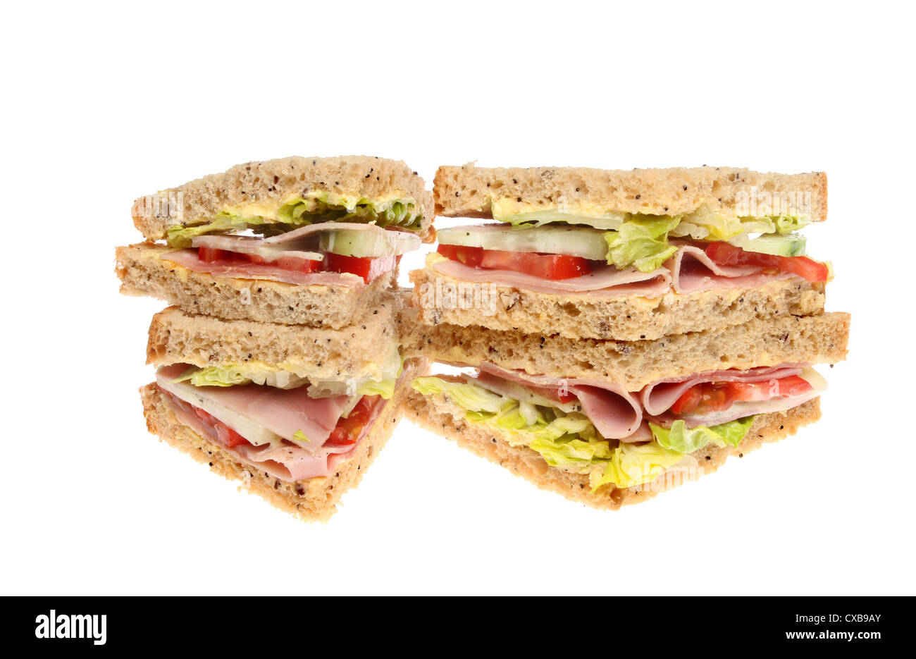 Stack of ham salad sandwiches with wholemeal bread isolated against ...