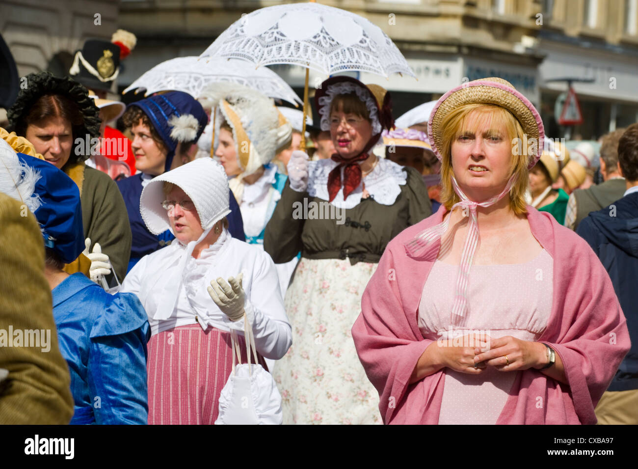 Ladies in Regency costume promenade through Bath city centre during the ...