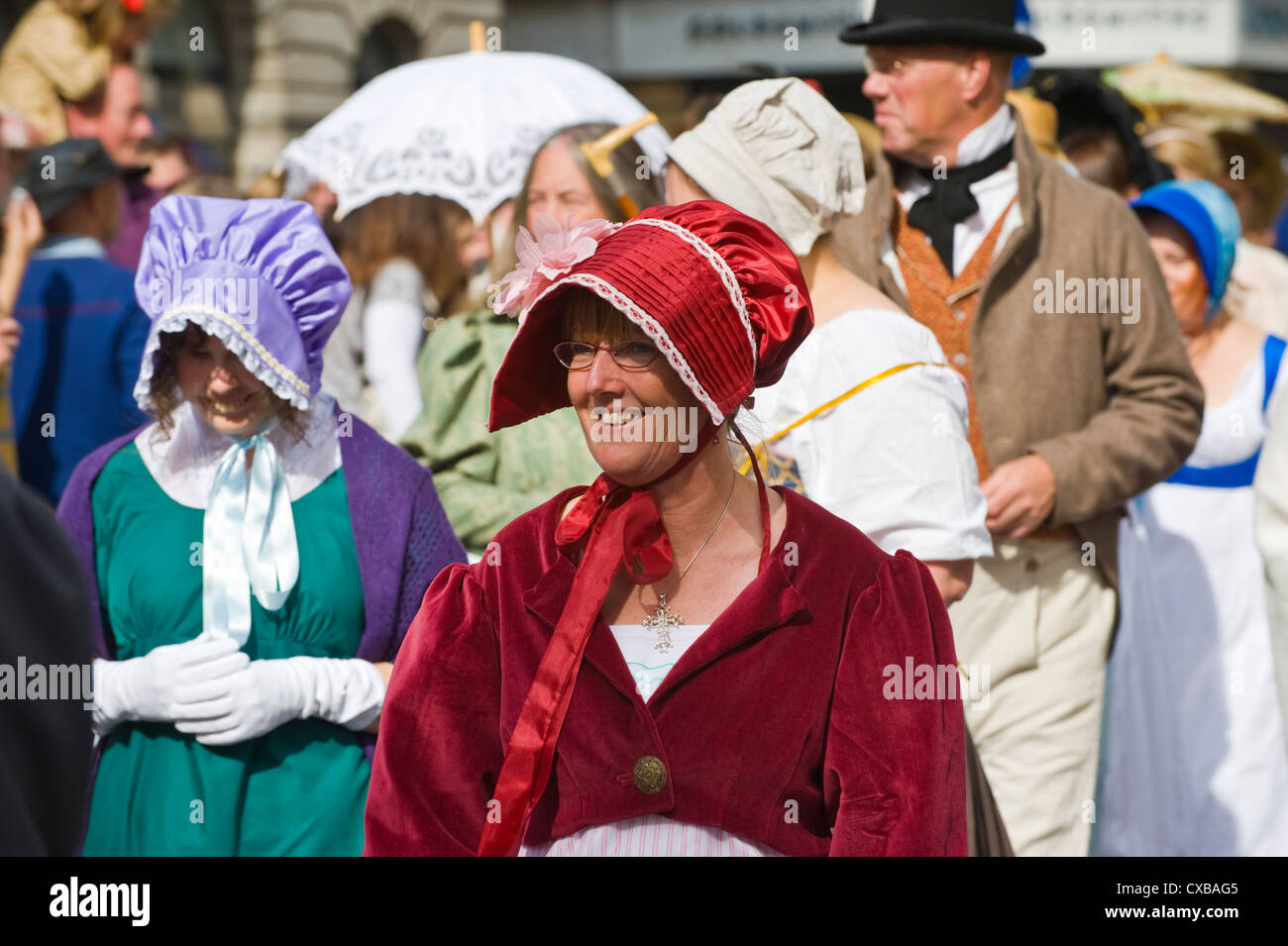 Ladies in Regency costume promenade through Bath city centre during the ...