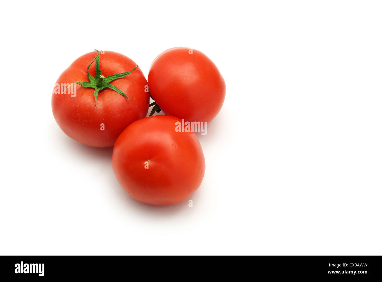 Three isolated tomatoes. Element of design Stock Photo - Alamy