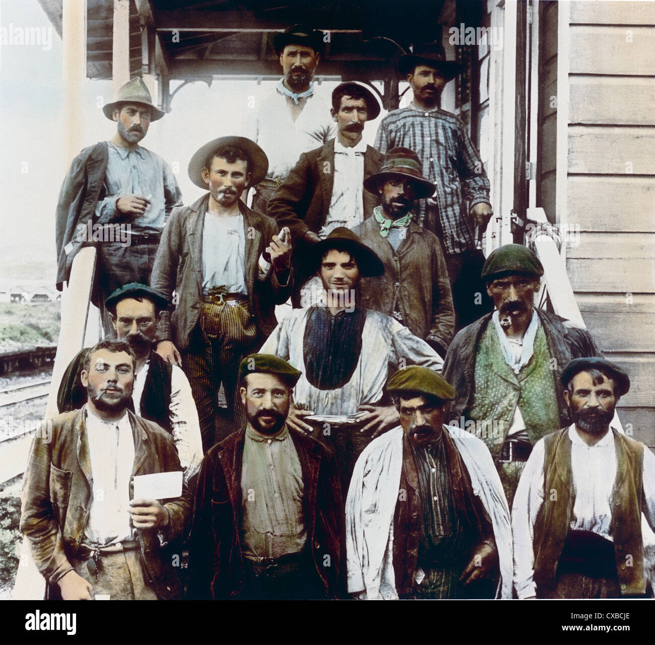 Colorized group portrait of Spanish male workers, some of the builders ...