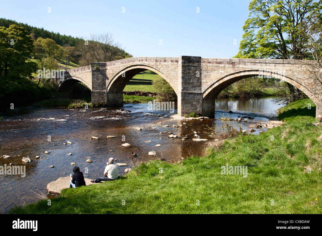 People eating ice cream at Barden Bridge over the River Wharfe ...
