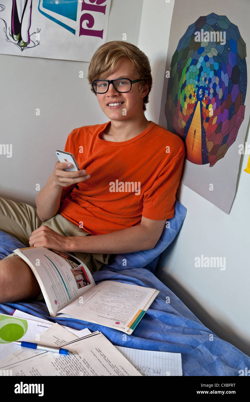Teenage boy texting in bed hi-res stock photography and images - Alamy