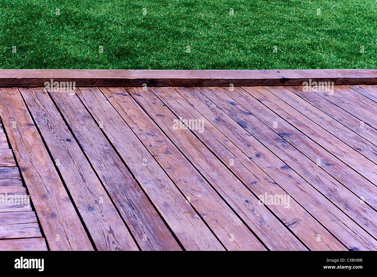 Fresh spring green grass with wood floor Stock Photo - Alamy