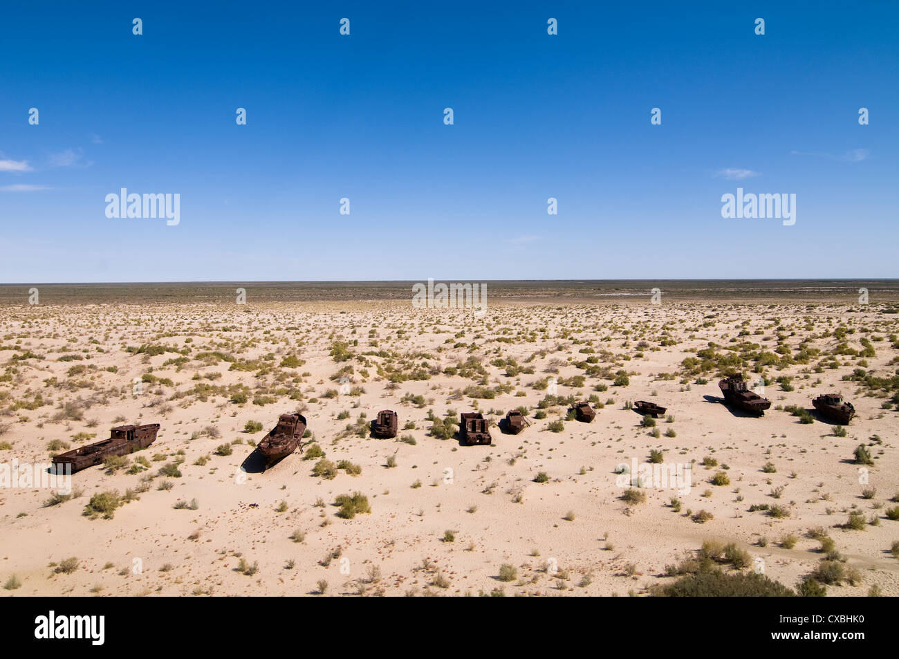 The remains of fishing boats lay on sea bed of the Aral sea Stock Photo ...